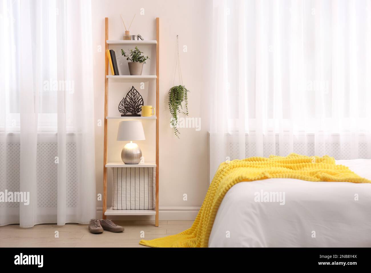 Stylish room interior with wooden ladder near white wall Stock Photo ...