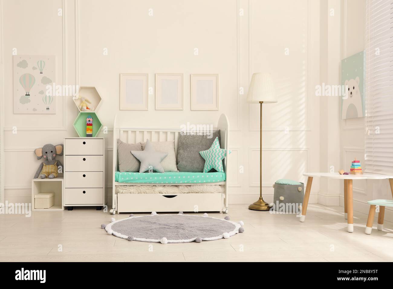 Cozy baby room interior with crib and toys Stock Photo - Alamy