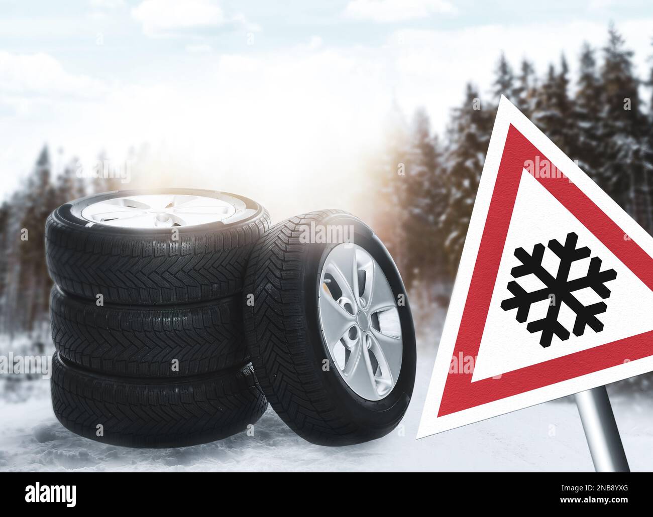 Set of wheels with winter tires on snow and road sign outdoors Stock ...
