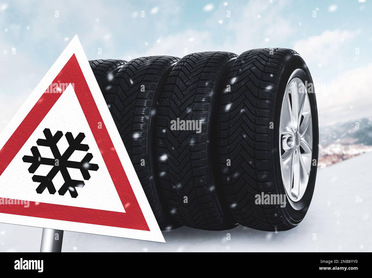 Set of wheels with winter tires on snow and road sign outdoors Stock ...
