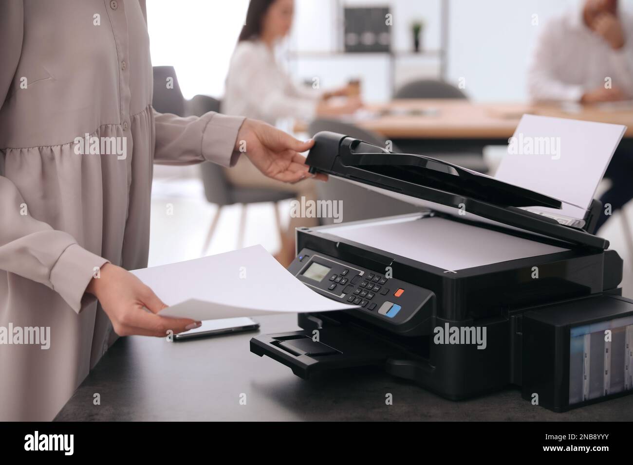 Employee using modern printer in office, closeup Stock Photo - Alamy