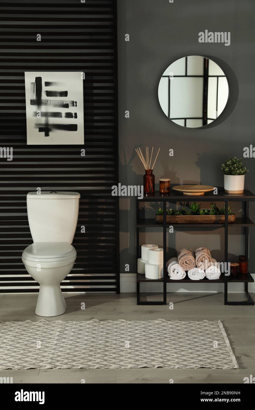 Modern bathroom interior with toilet bowl and console table Stock Photo ...