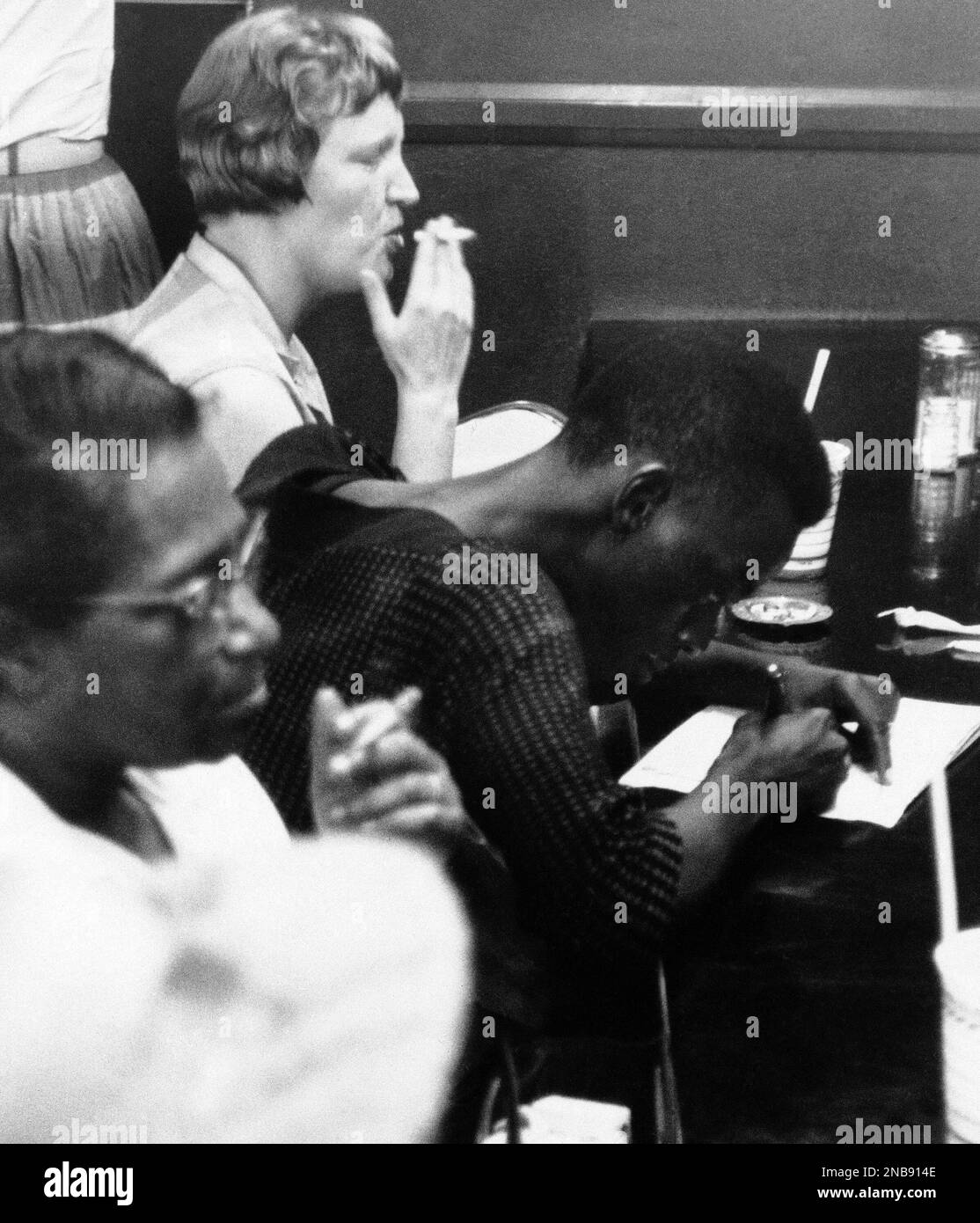 Norma Wagner, 33, Rochester, N.Y., background, smokes a cigarette in a ...