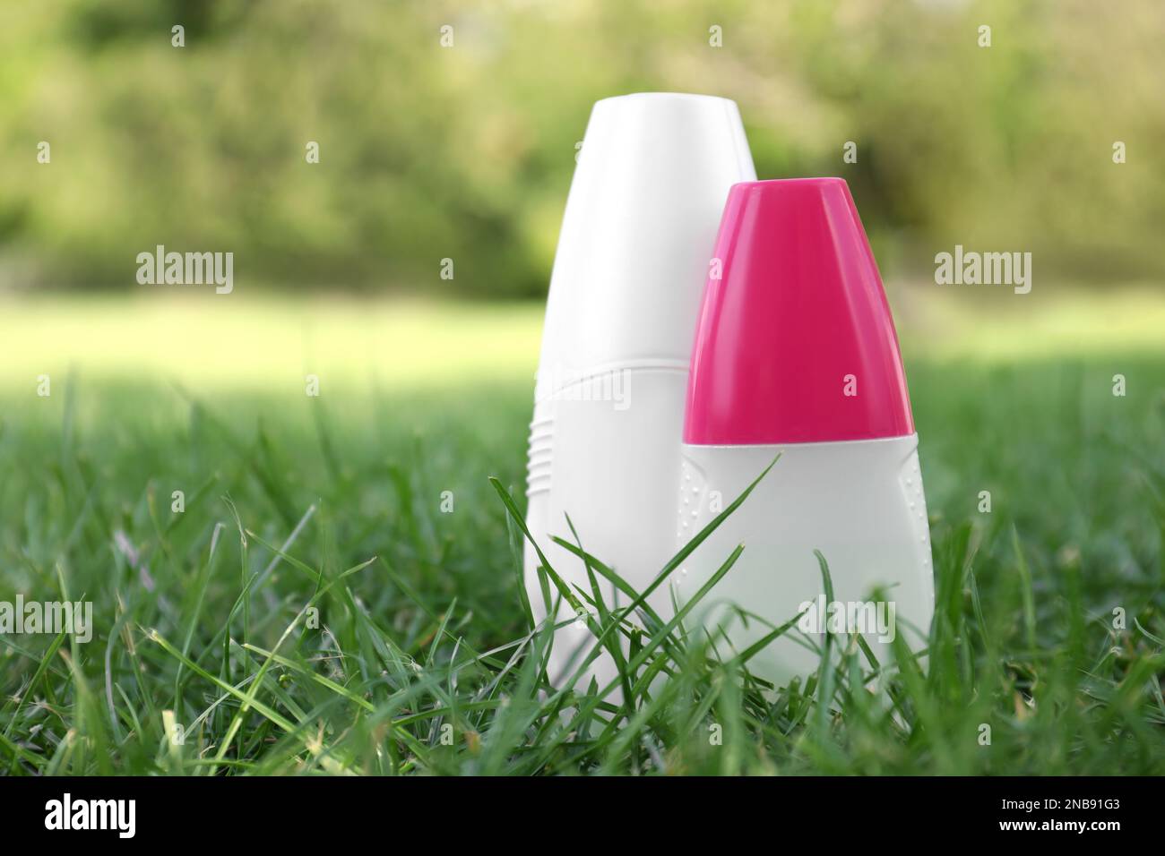 Bottles of insect repellent on green grass Stock Photo - Alamy