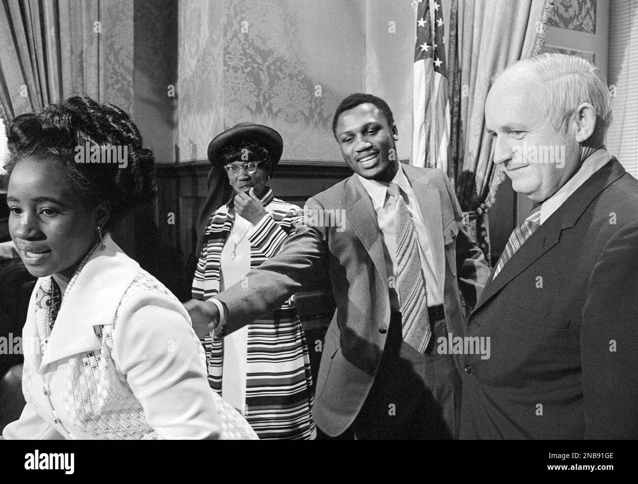 Heavyweight boxing champ Joe Frazier reaches for his wife who stepped ...