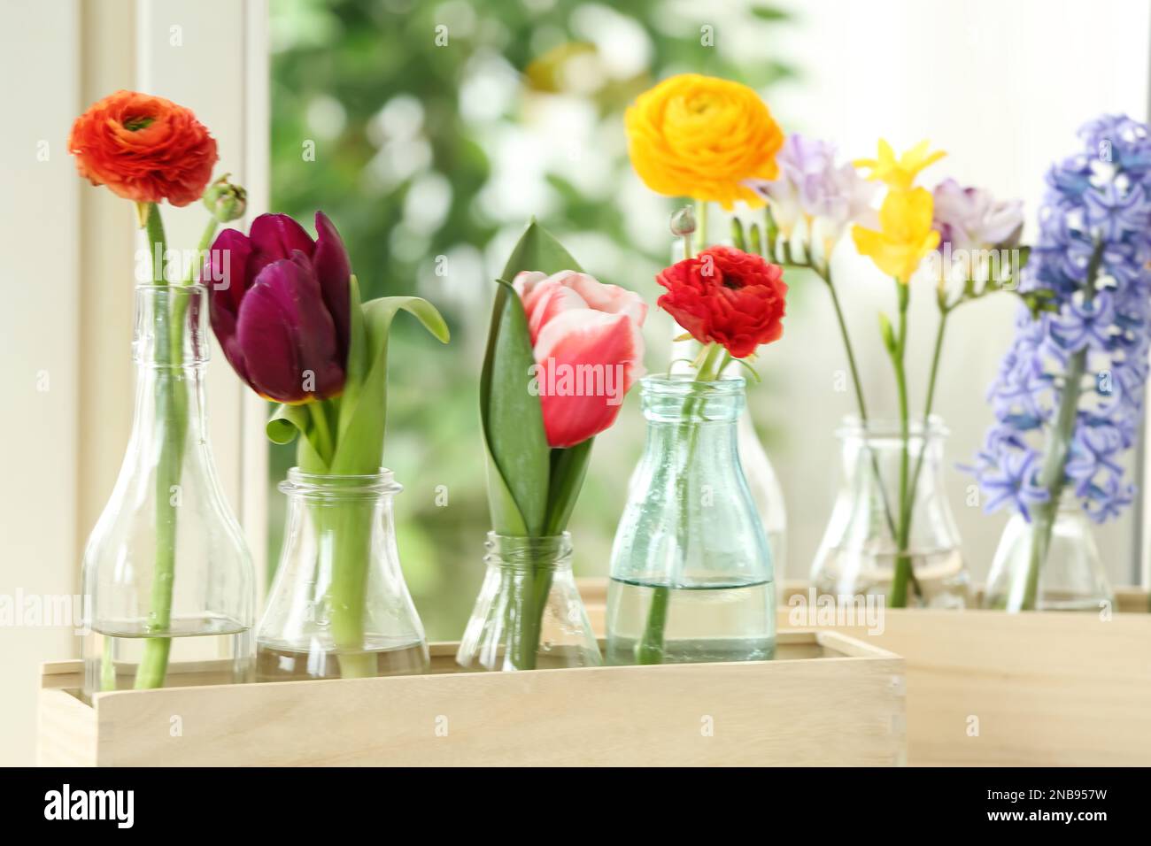 Beautiful spring flowers in wooden crates on window sill Stock Photo ...