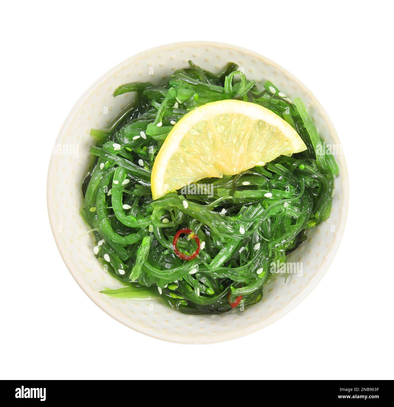 Japanese seaweed salad with lemon slice in bowl isolated on white, top ...