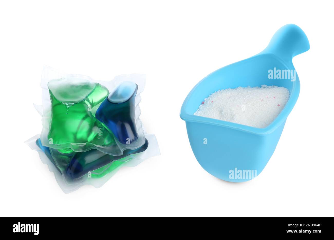 Laundry capsules and measuring scoop of washing powder on white ...