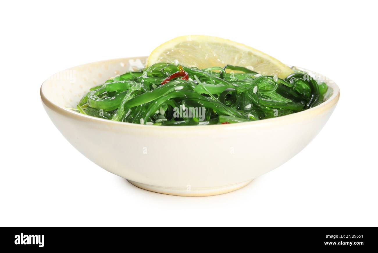 Japanese seaweed salad with lemon slice in bowl isolated on white Stock ...