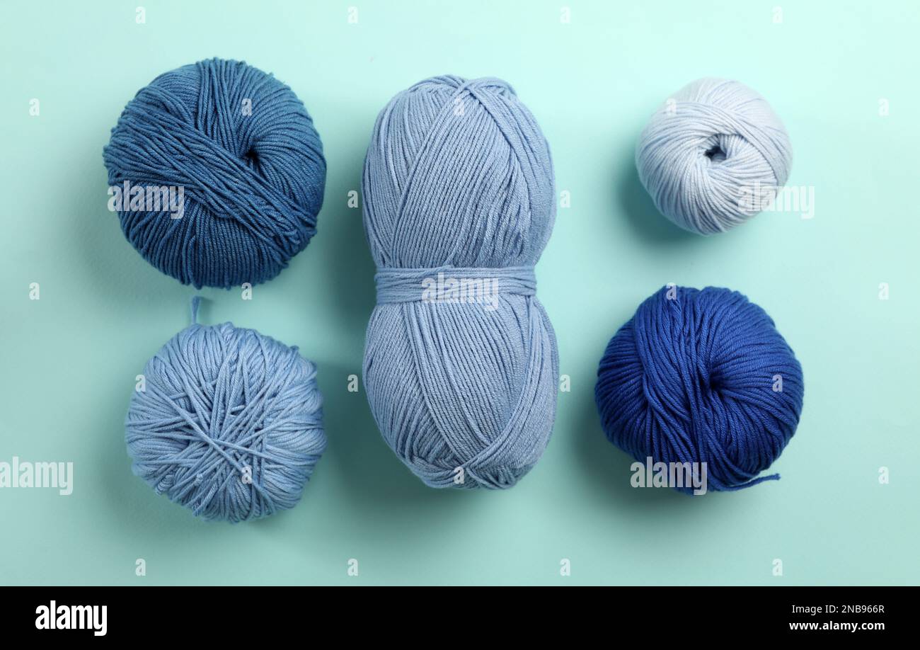 Soft woolen yarns on light blue background, flat lay Stock Photo - Alamy