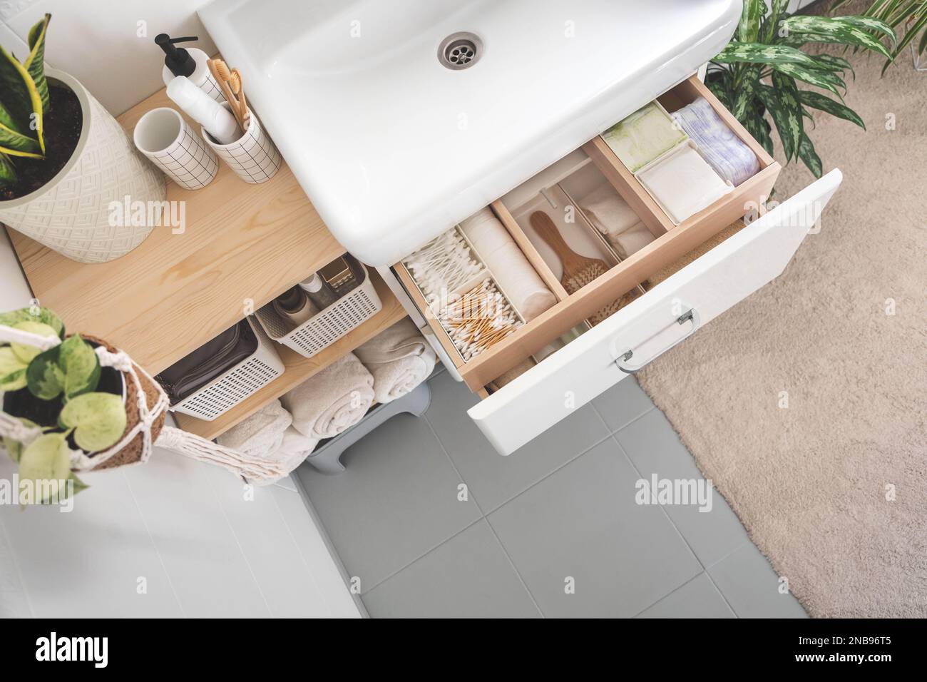 Bathroom under sink organizer drawers with neatly placed bath amenities ...