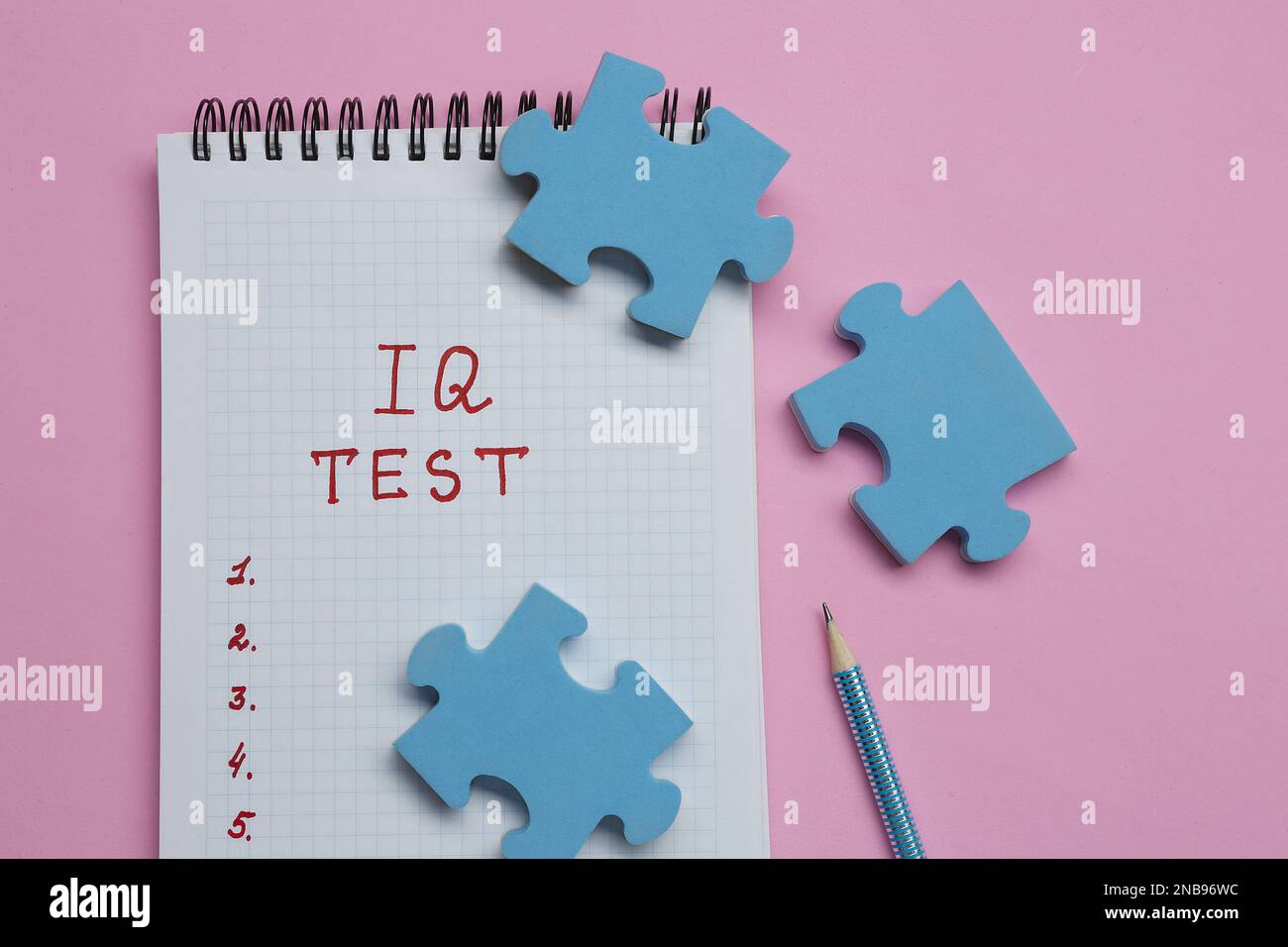 Notepad with text IQ Test, pencil and puzzle pieces on pink background ...