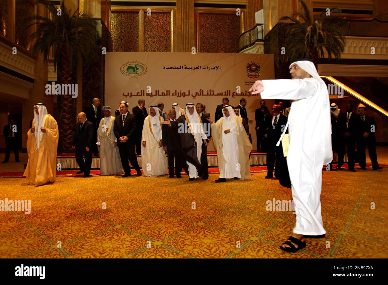 An Emirati official guides the Arab finance ministers to the meeting ...