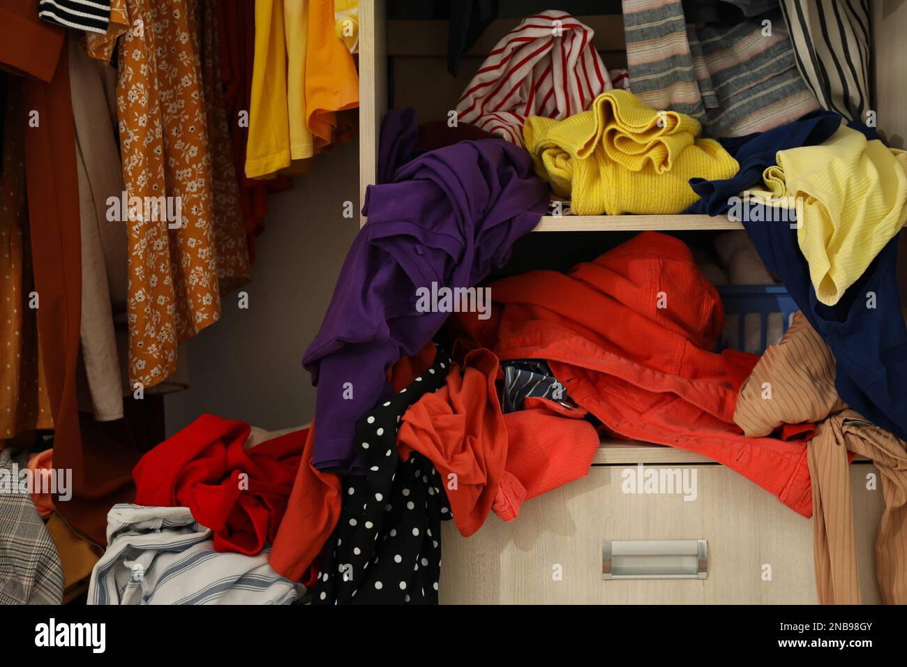 Messy wardrobe with different clothes. Fast fashion concept Stock Photo ...