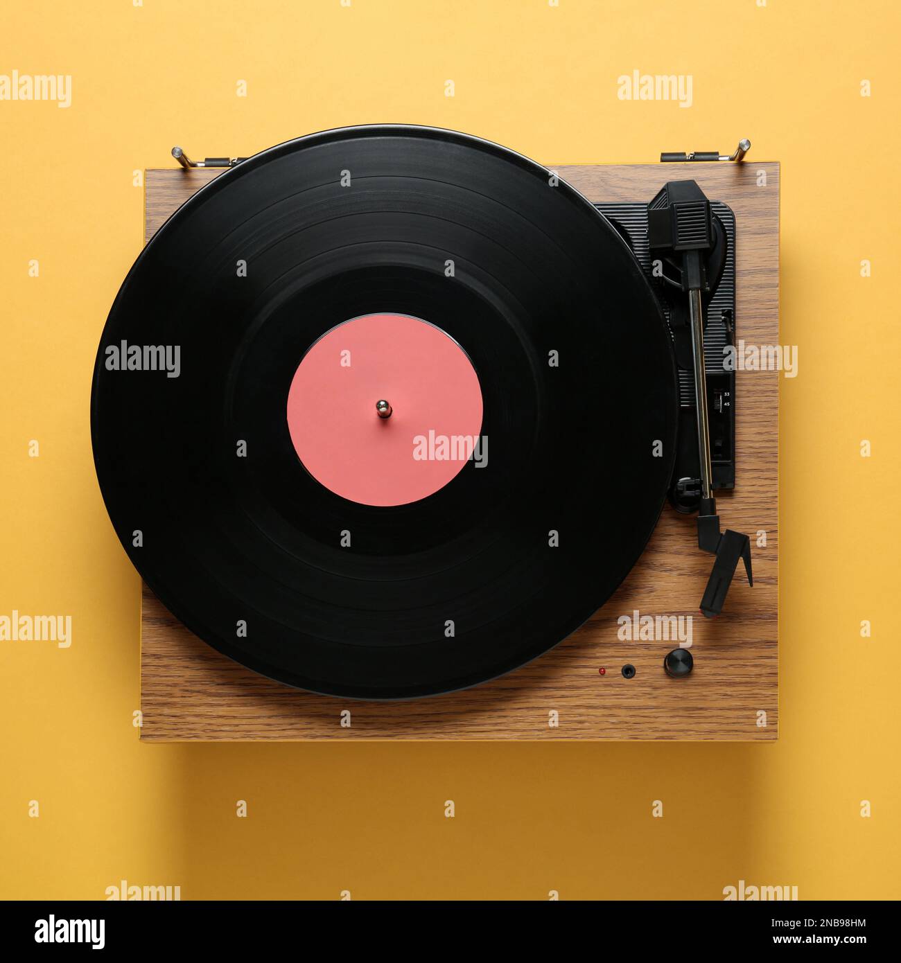 Modern turntable with vinyl record on orange background, top view Stock ...