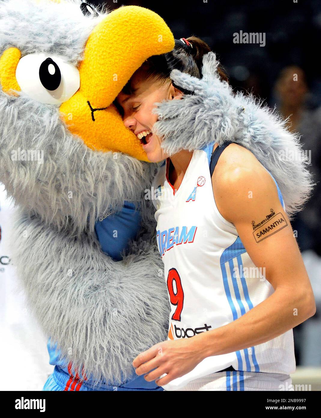 Atlanta Dream guard Coco Miller (9) gets a hug from mascot Star while ...