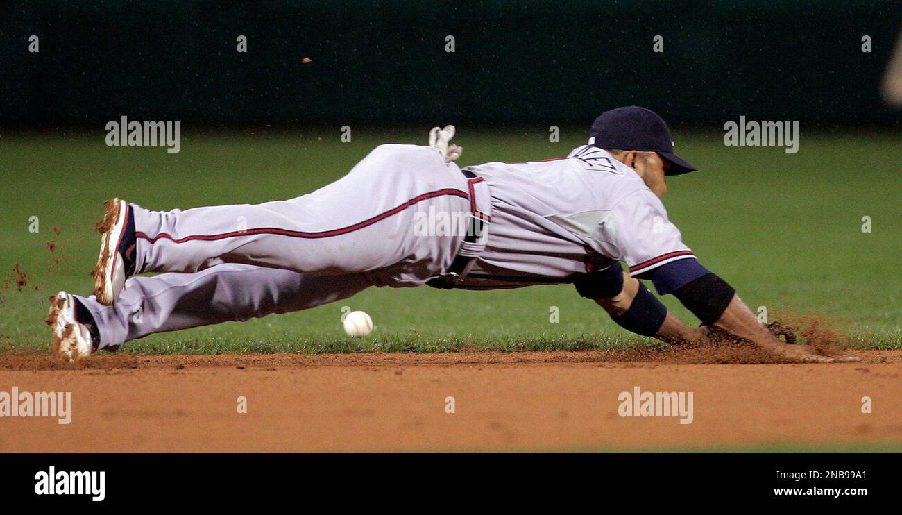 Atlanta Braves shortstop Alex Gonzalez fails to get the ball hit by ...
