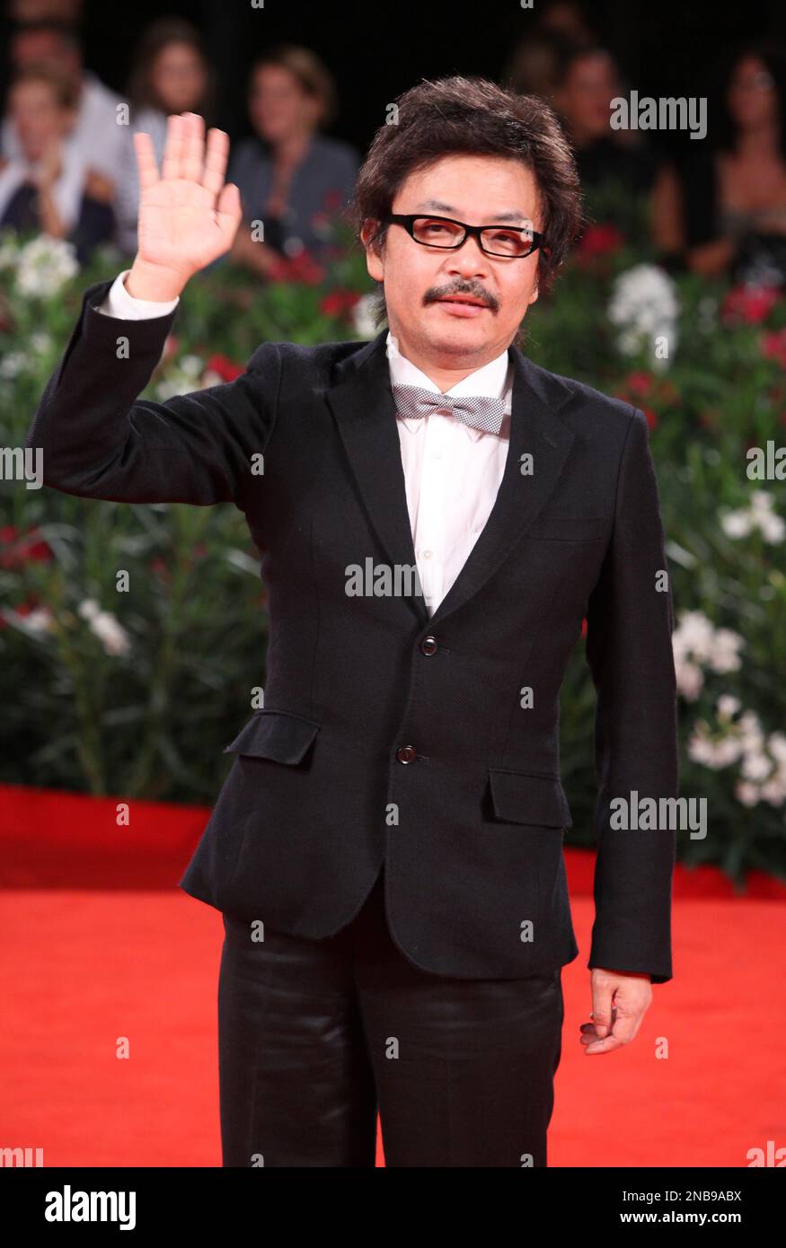 Director Sono Sion arrives on the red carpet for the premiere of the ...