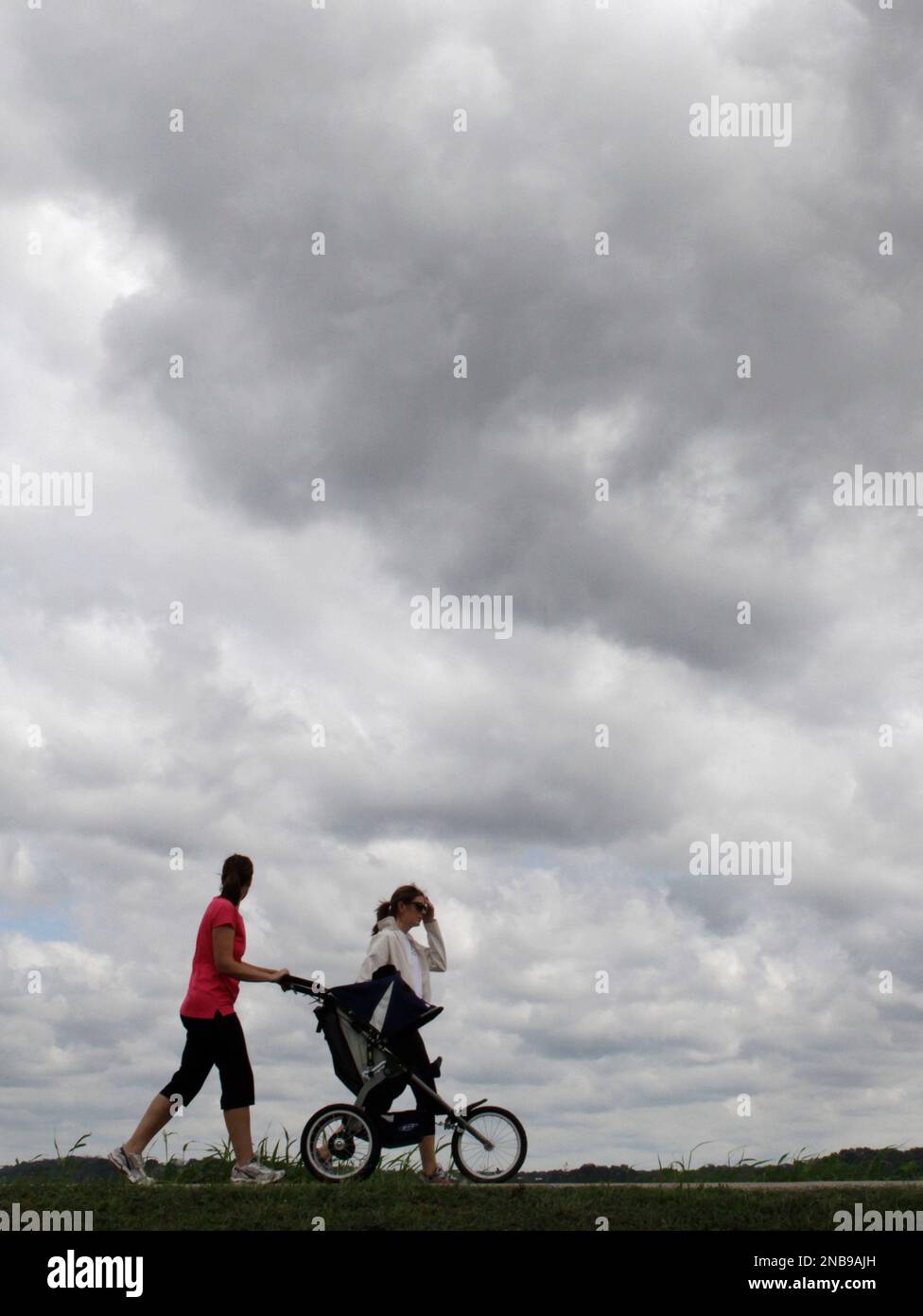 Melanie Thorp, left, and Allison Briscoe walk on the bike path around ...
