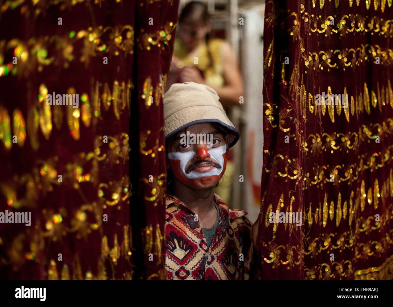 A Pakistani clown waits for his turn to perform at a local circus show ...