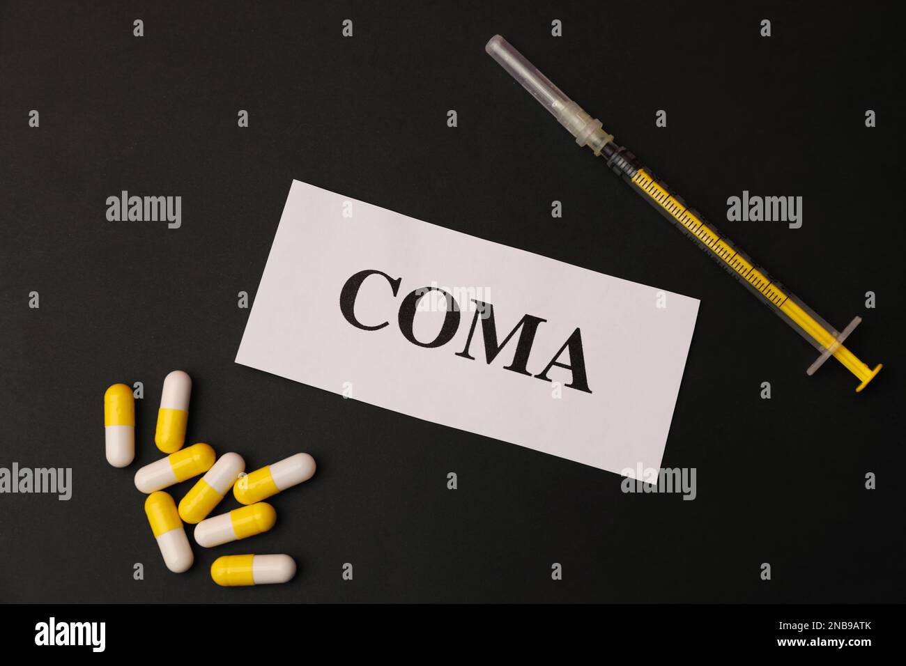 Card with word Coma, syringe and pills on black background, flat lay ...