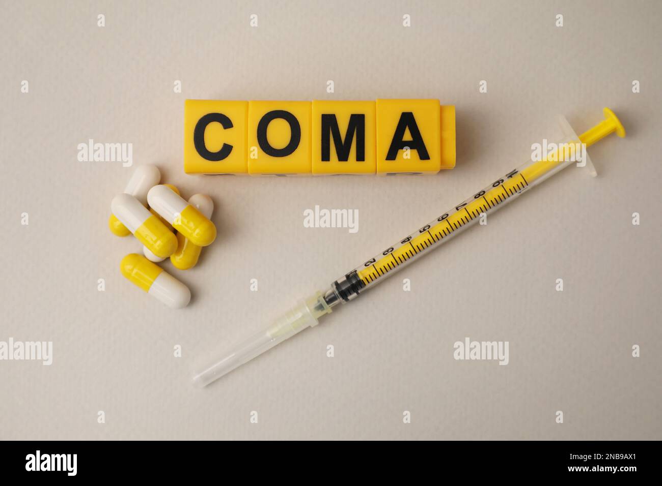 Word Coma of cubes, syringe and pills on beige background, flat lay ...