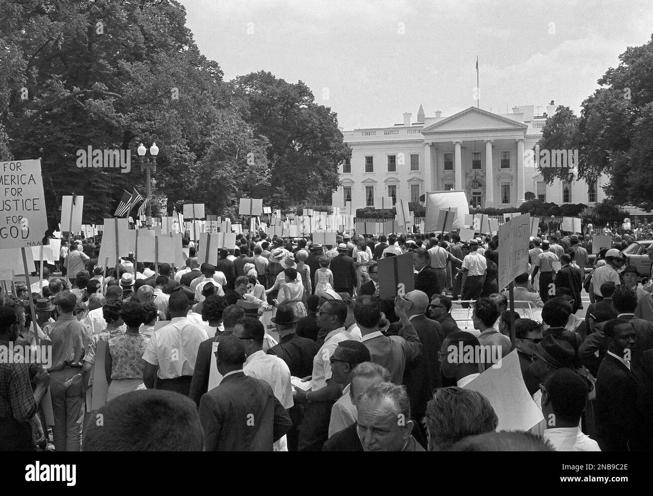 Demonstrators, numbering hundreds of blacks and whites, move across ...