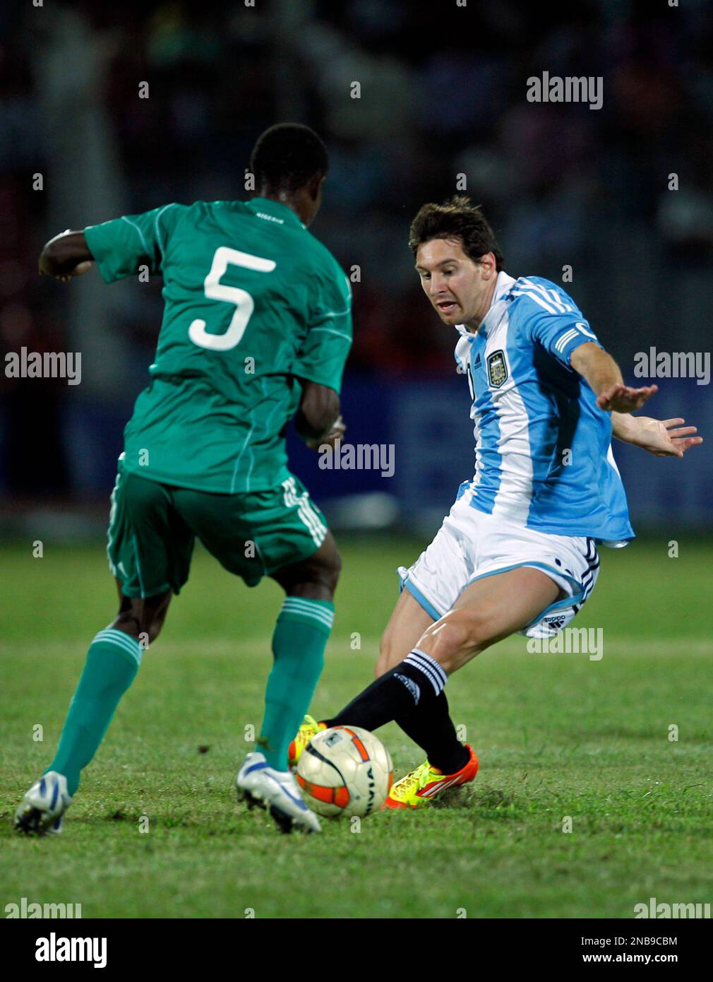 Argentina's Lionel Messi vies for the ball with Nigeria's Ambrose Efe ...