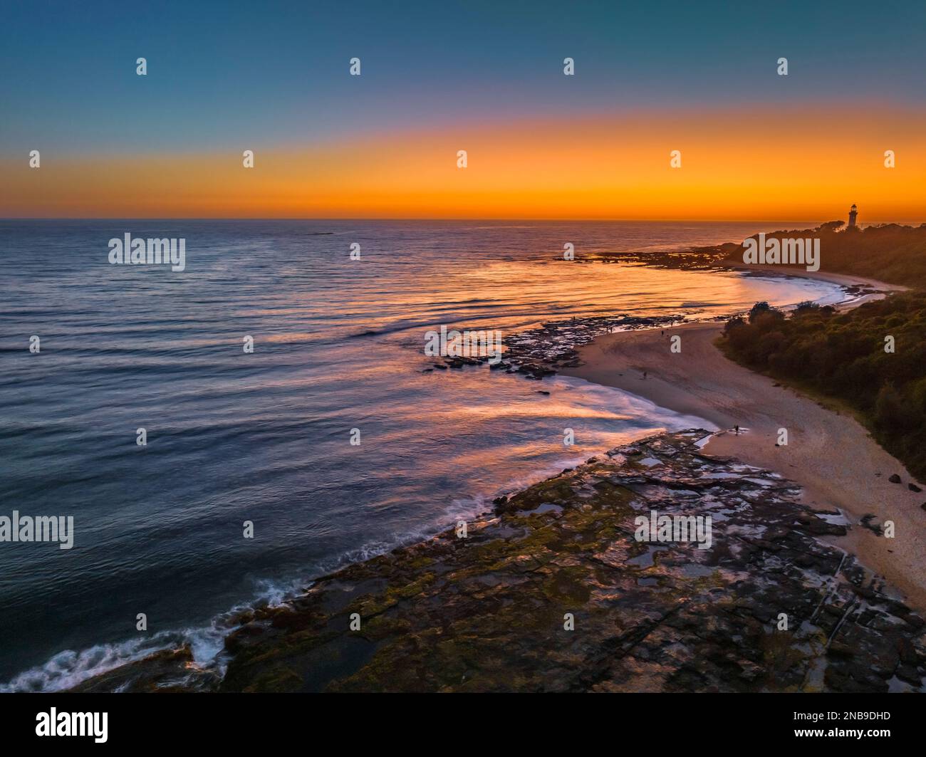 Aerial sunrise seascape from the sheltered bay of Cabbage Tree Harbour ...
