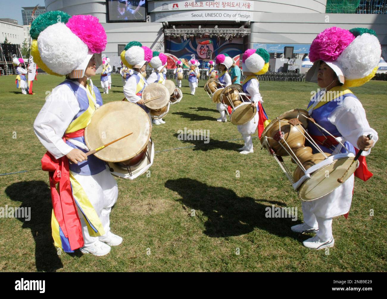 South Korean farmers in traditional costumes beat drums in celebration ...