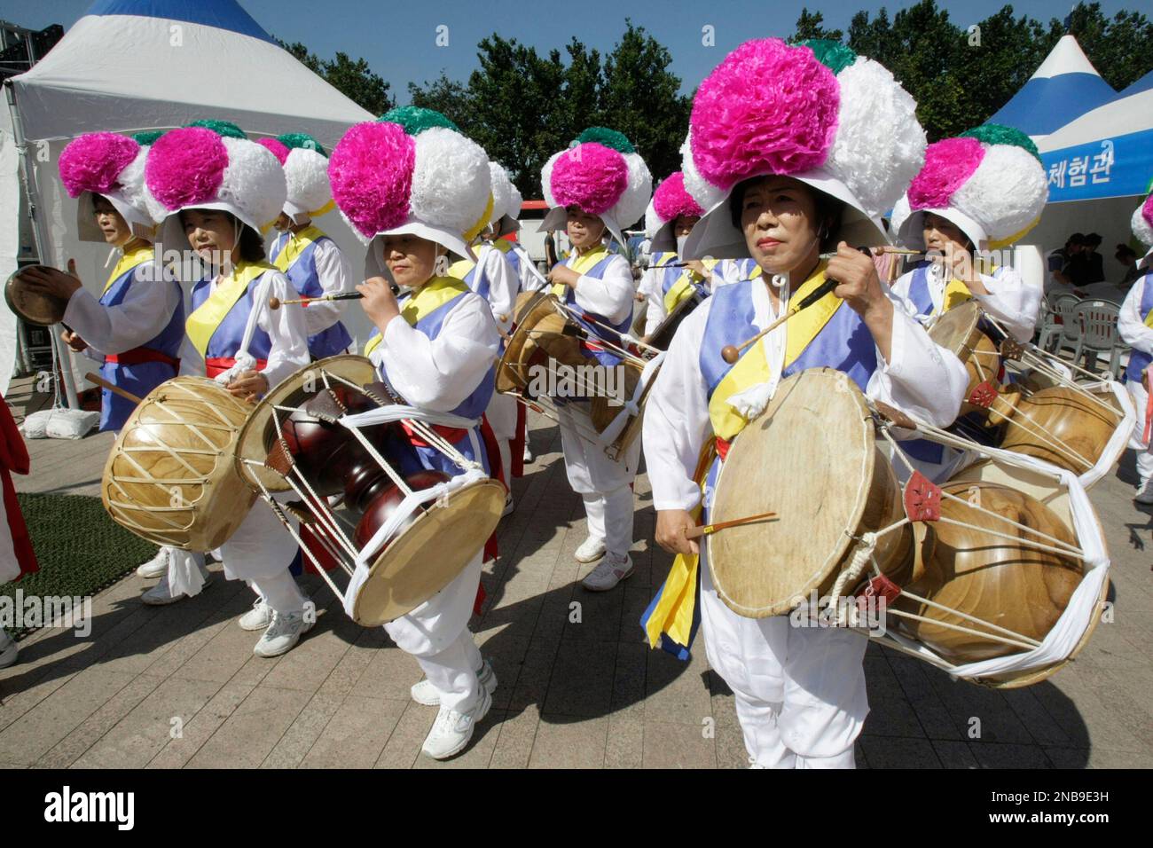 South Korean farmers in traditional costumes beat drums in celebration ...