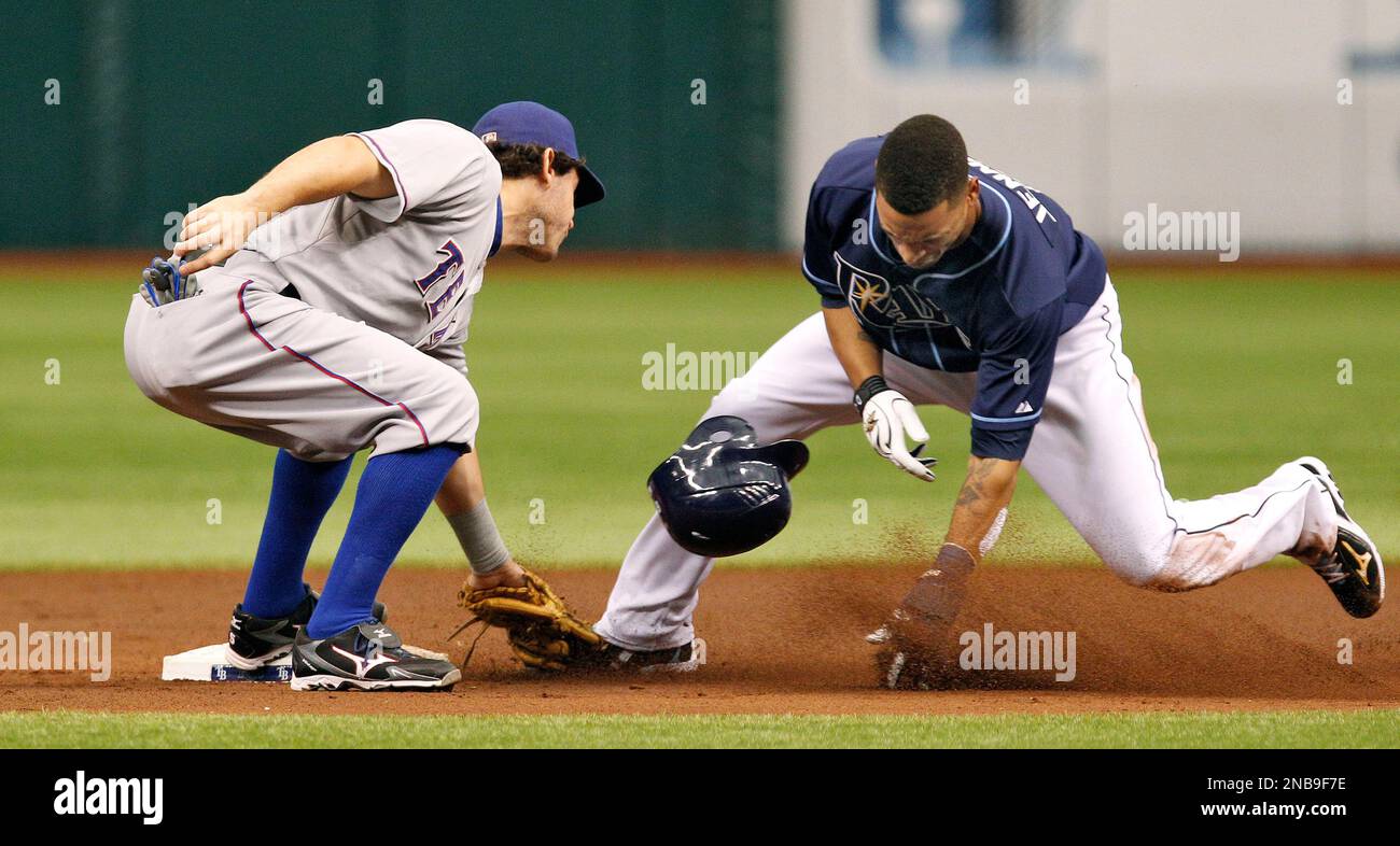 Tampa Bay Rays' Desmond Jennings, right, loses his helmet as he is ...