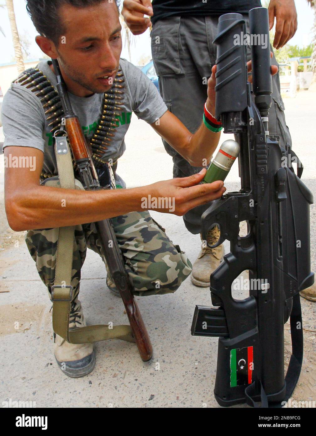 Libyan rebels show a FN F2000 assault rifle with grenade launcher they ...
