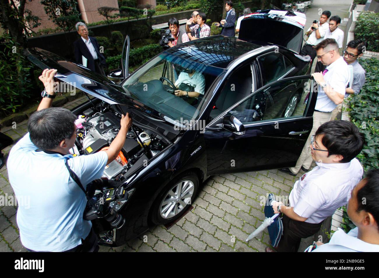 Journalist check a redesigned Toyota Camry at a press event marking its ...