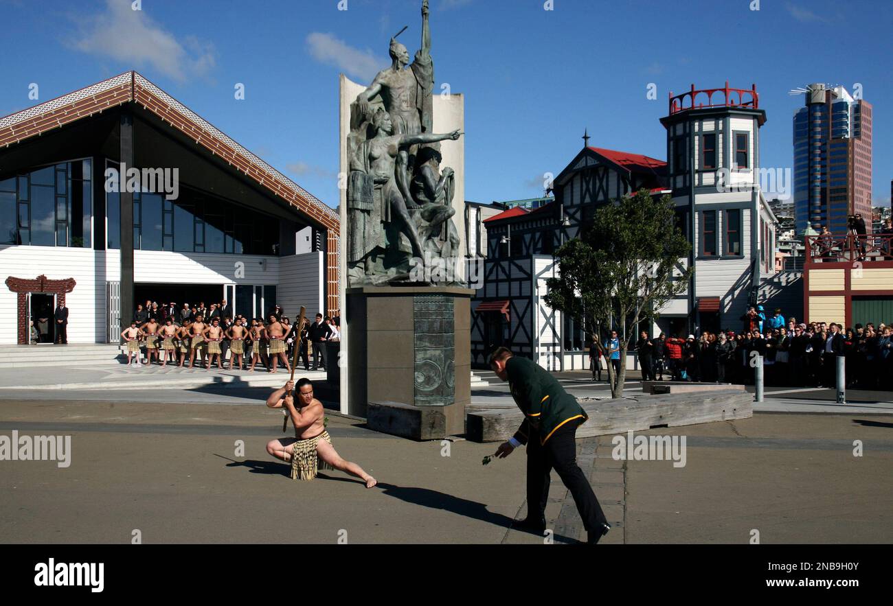Maori warrior Toa Waaka, center, looks on as captain John Smit of South ...