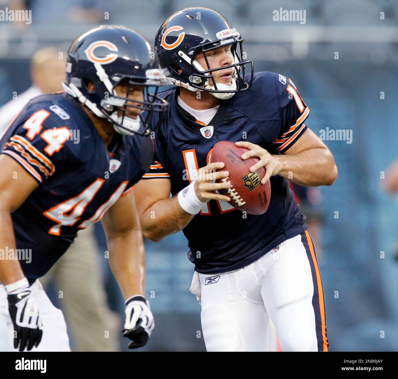 Chicago Bears quarterback Caleb Hanie, right, looks to a throw before ...