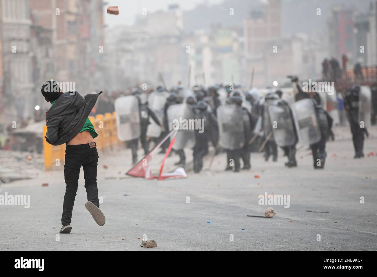 Kathmandu, Nepal. 13th Feb, 2023. Protester hurls stones at the riot ...