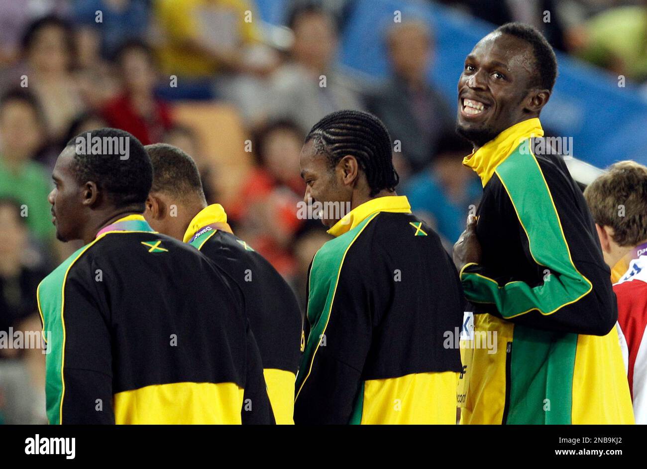 Jamaica's Usain Bolt, right, smiles with his relay team during the ...