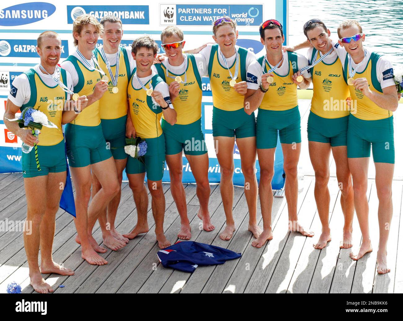 The team of Australia display their gold medals on the podium of the ...
