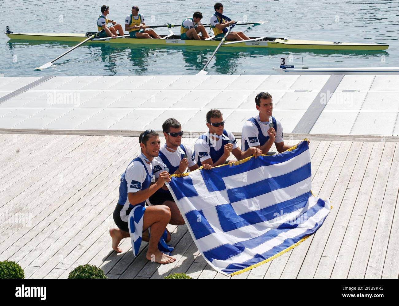 The team of Greece display their silver medals and their national flag ...