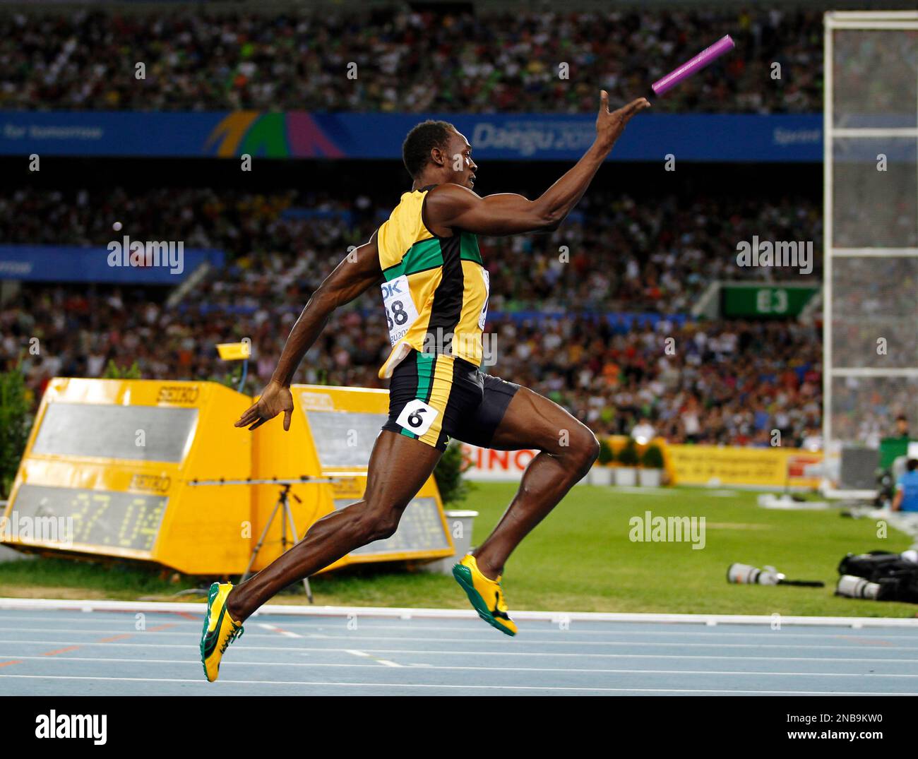 Jamaica's Usain Bolt throws the baton into the air as he celebrates winning the Men's 4x100 ...