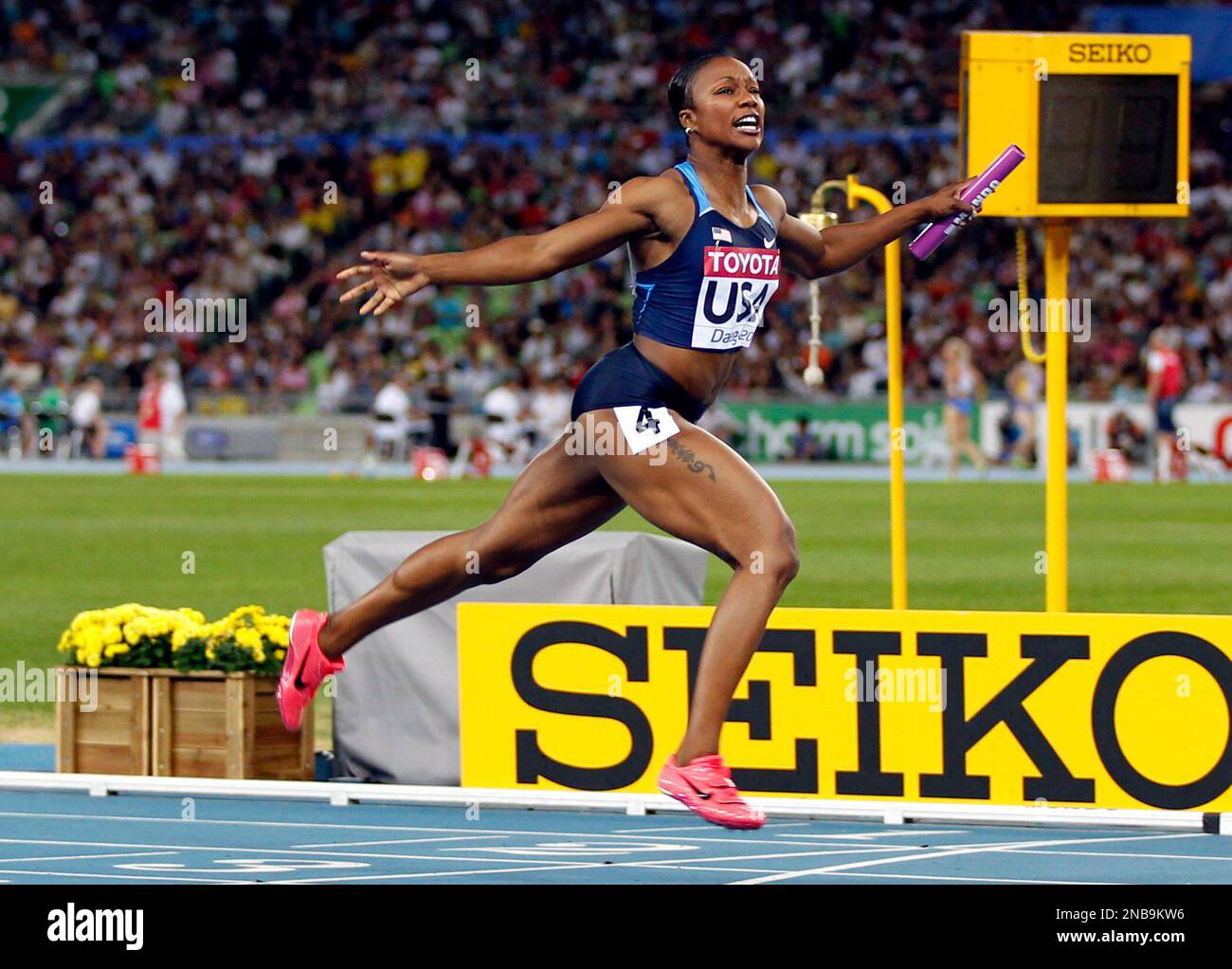 USA's Carmelita Jeter crosses the finish line winning the gold in the ...