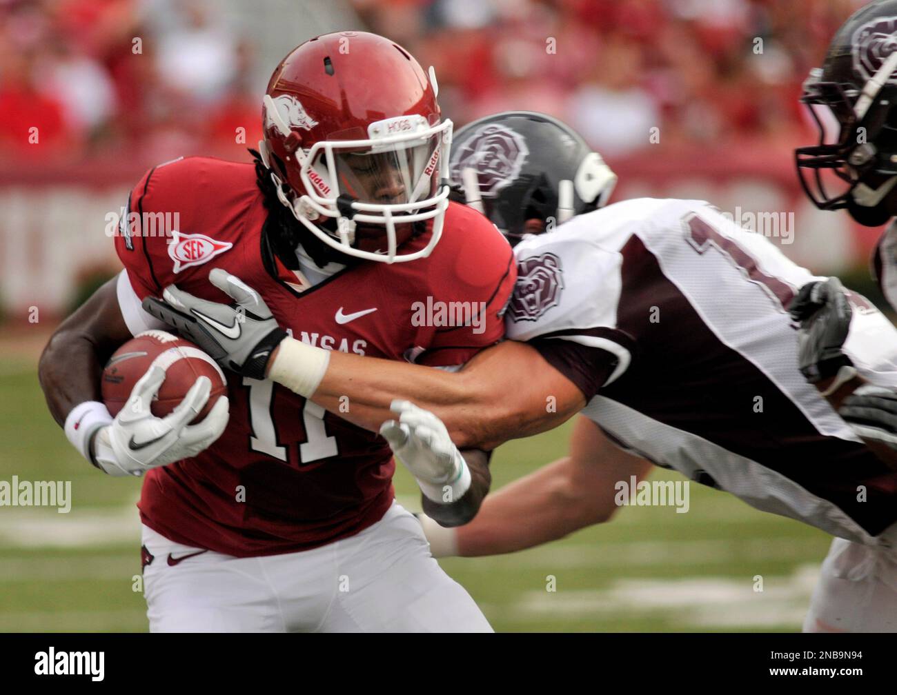Arkansas wide receiver Cobi Hamilton (11) is brought down by Missouri ...