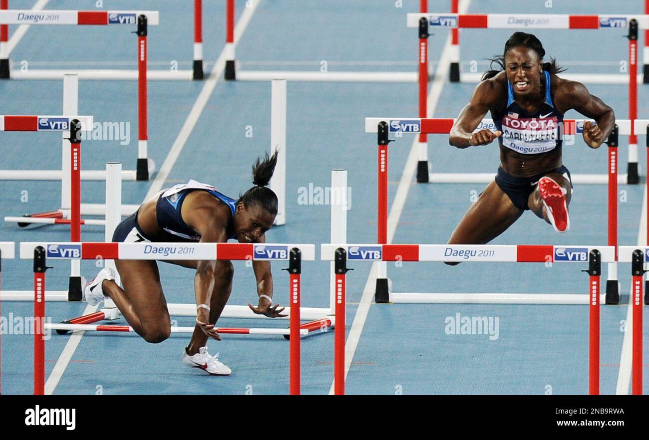 USA's Kellie Wells, left, fails to clear a gate as she competes beside ...