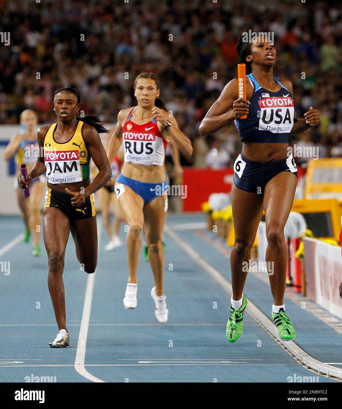 USA's Francena McCorory, right, crosses the finish line ahead of ...