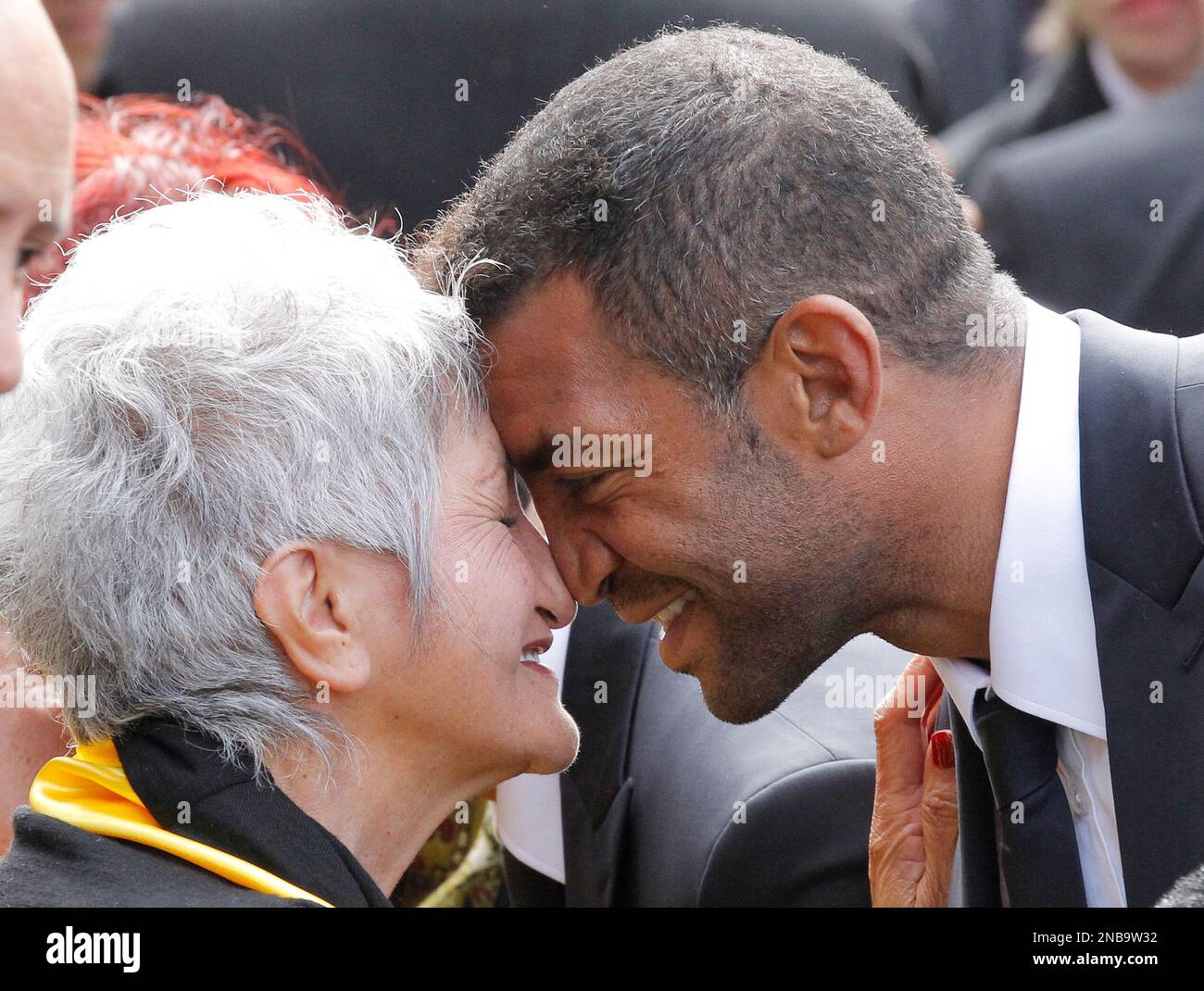 French back coach Emile Ntamack, right, performs a hongi, a traditional ...