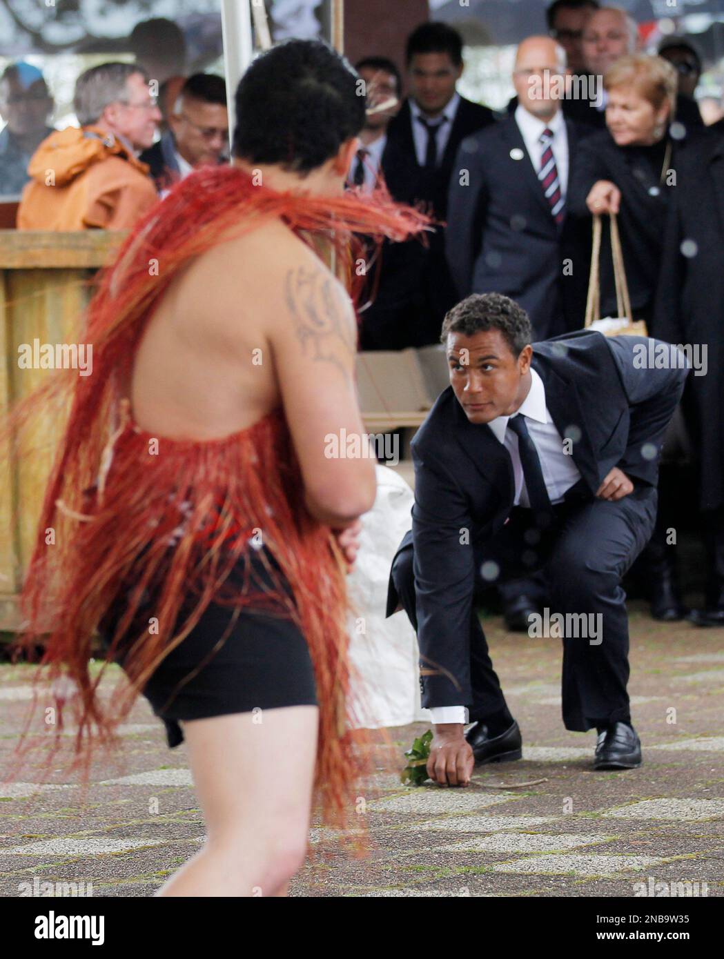 The French rugby team captain Thierry Dusautoir, right, accepts the ...