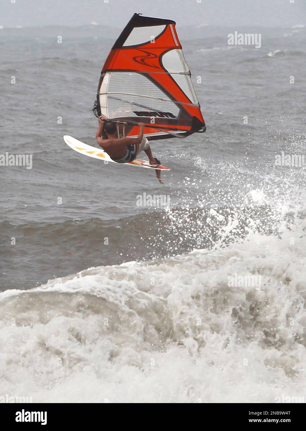 A windsurfer goes airborne at Nishihama beach in Fujisawa, near Tokyo ...