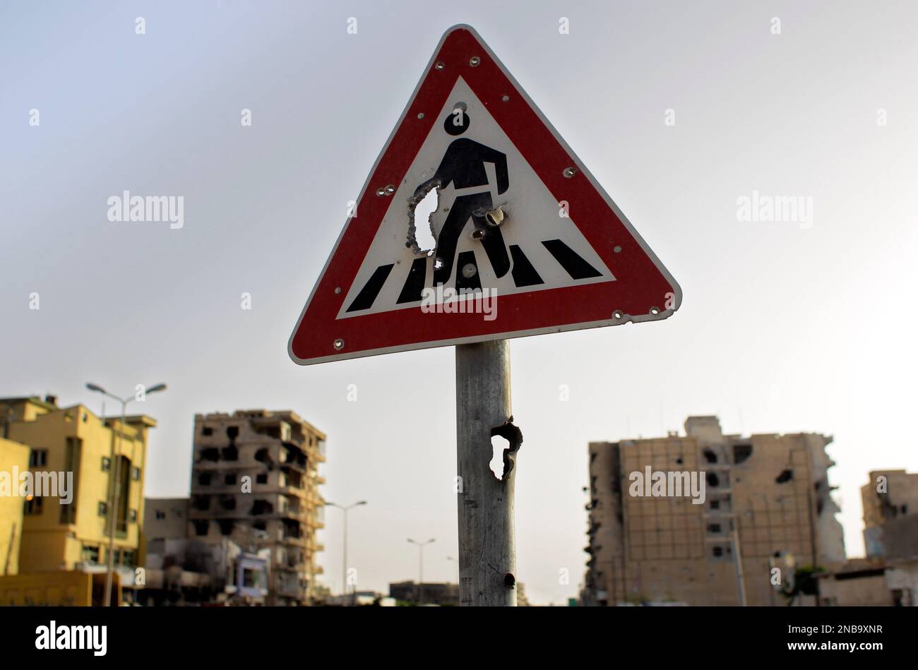 A foot crossing road sign with holes seen at Tripoli street in Misrata ...
