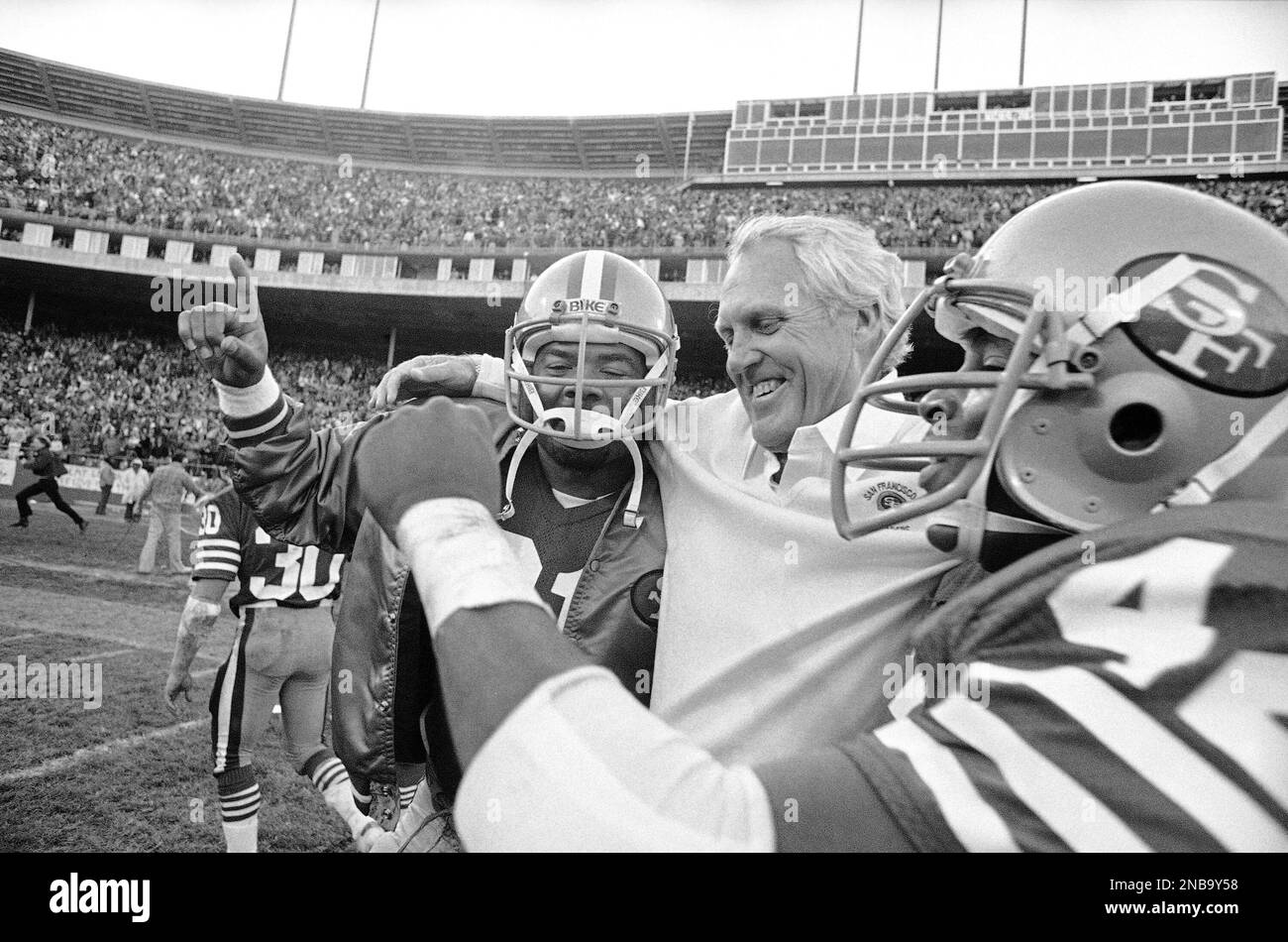 San Francisco 49ers coach Bill Walsh is hugged by 49ers back Walt ...